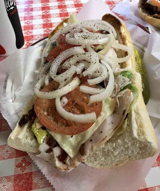 Fresh tomatoes, crisp lettuce, and perfectly layered meat: this is sandwich architecture at its finest.