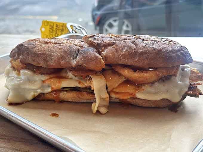Sandwichitos' Dirty South brings Southern comfort north with crispy onion rings and buffalo sauce creating beautiful chaos together.