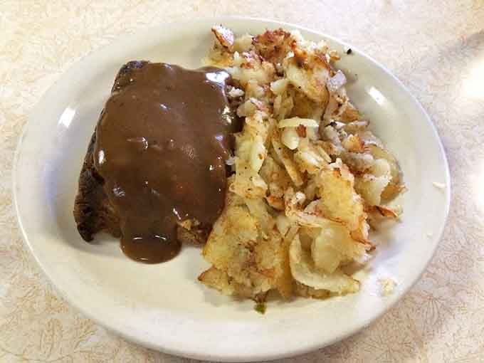 Meatloaf with gravy and crispy home fries, proving comfort food doesn't need a fancy zip code to excel.