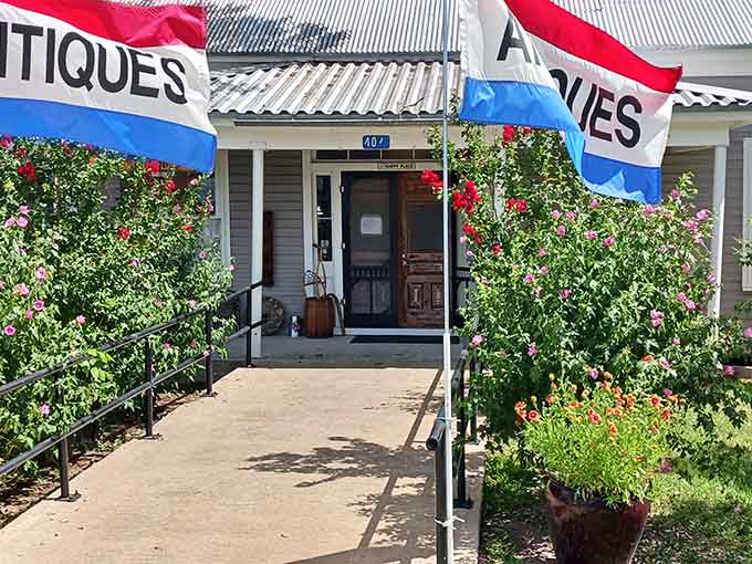 Red, white, and blue bunting frames this antique shop entrance like a patriotic hug welcoming you to browse treasures.