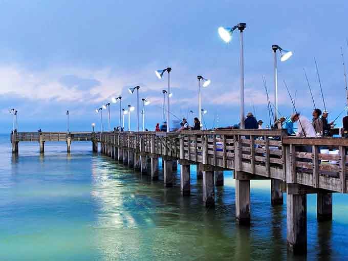 Evening fishing at the pier turns into a meditation session with lights reflecting off calm waters.