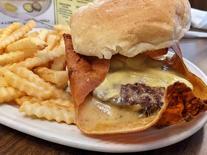 That cheese skirt extending beyond the patty is pure griddle magic, crispy enough to shatter with every bite.