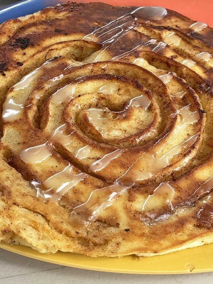 That cinnamon roll pancake spiral with glaze is basically a work of art you're allowed to destroy with a fork.