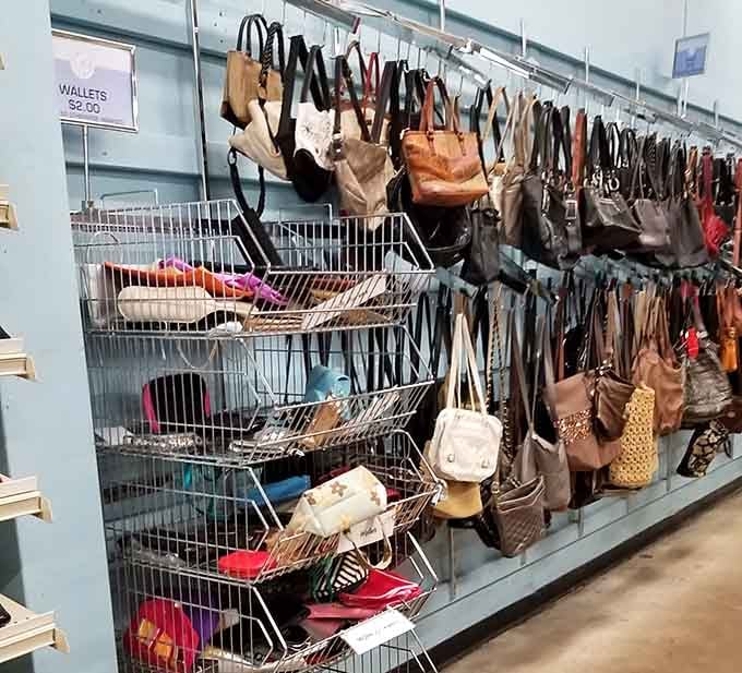 A wall of purses hangs like a fashion museum, offering everything from practical totes to statement pieces that spark joy.