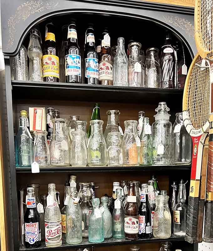 Vintage bottles line up like soldiers of nostalgia, each one telling stories of sodas and brews long gone.