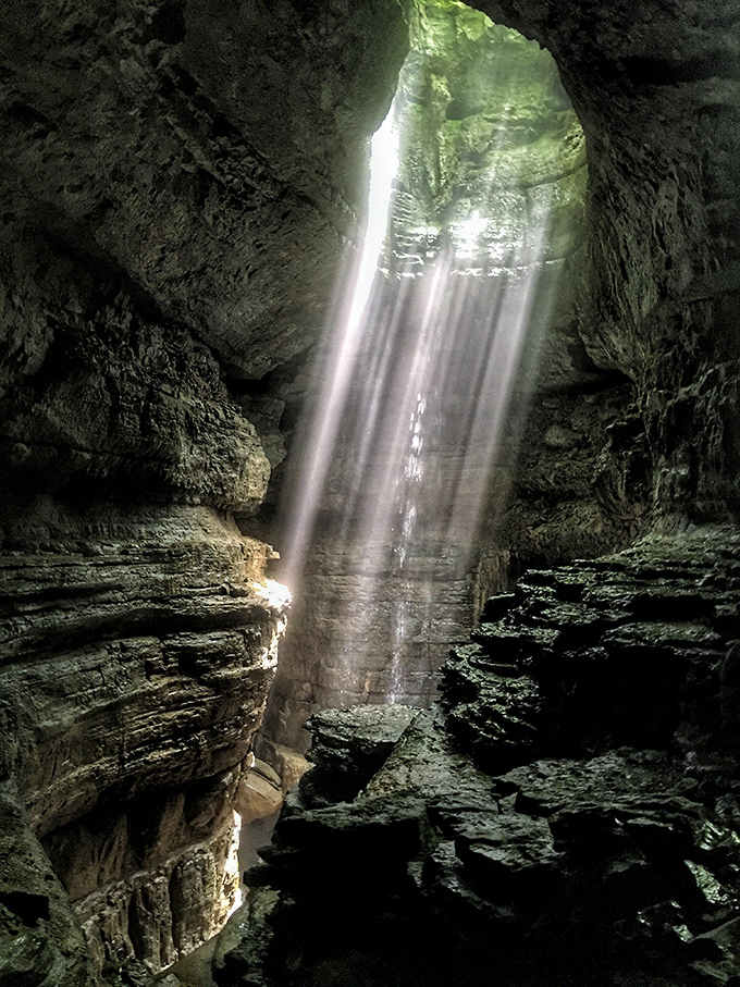 When sunlight meets underground waterfall, you get the kind of magic that makes photographers weep with joy and frustration simultaneously.