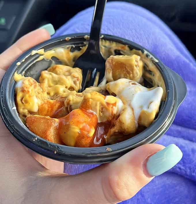 Cheesy Fiesta Potatoes swimming in sauce, proving that potatoes are the ultimate comfort food canvas.