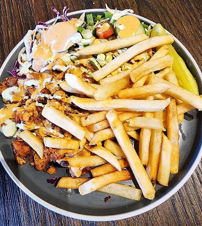 Crispy chicken kebab with fries that would make your grandmother proud, pickle included for authenticity.