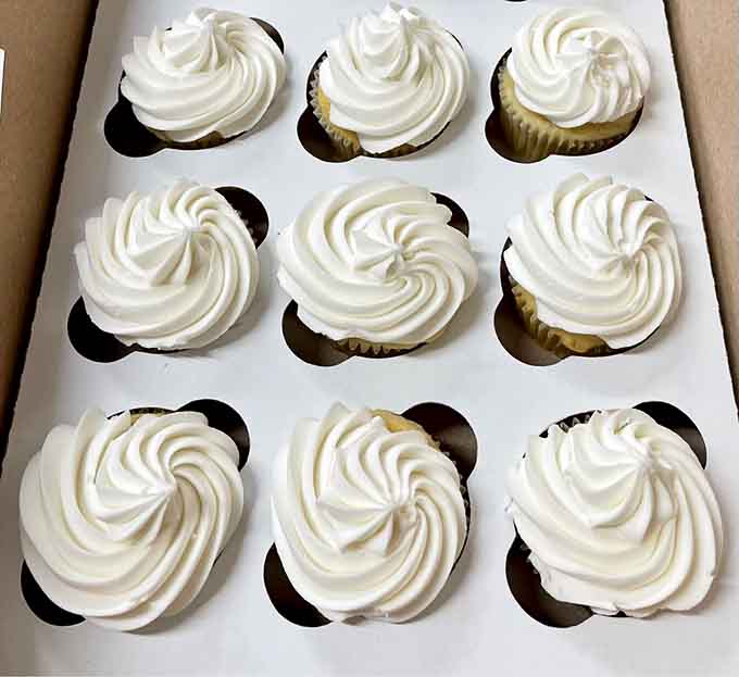 Cupcakes topped with frosting swirls so perfect they could make a pastry chef weep with envy and admiration.