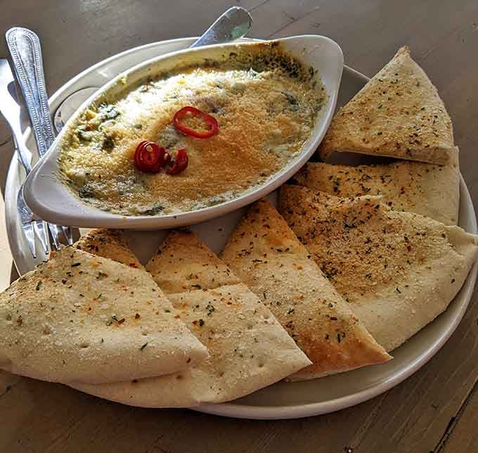 Bubbling spinach dip with warm pita triangles is the kind of shareable that nobody actually wants to share.