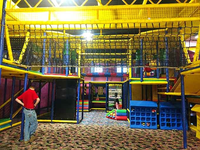 The play structure towers overhead like a colorful jungle gym designed by someone who really understood childhood dreams.