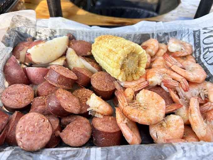 Shrimp, sausage, corn, and potatoes all partying together like it's a coastal family reunion on a platter.