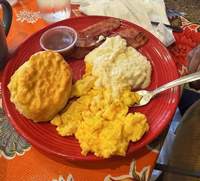 That towering biscuit paired with fluffy scrambled eggs is the kind of plate that makes diets take a vacation.