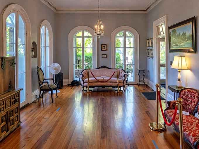 Arched windows, polished floors, and period furniture create an elegant space where cats now hold court.