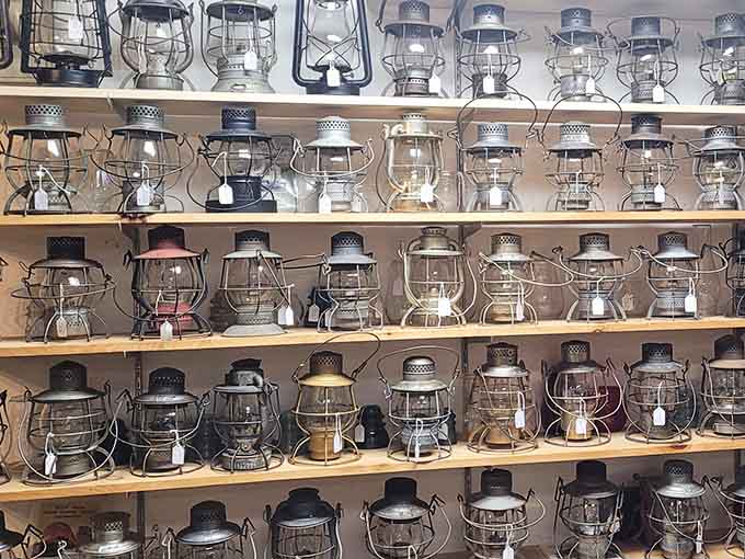 Railroad lanterns line the shelves like sentinels from another era, each one a beacon of industrial history.