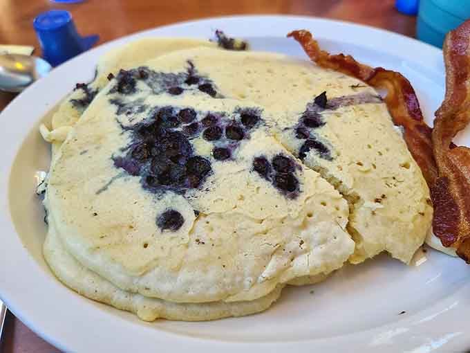 Those blueberries are having the time of their lives nestled in that fluffy pancake perfection.