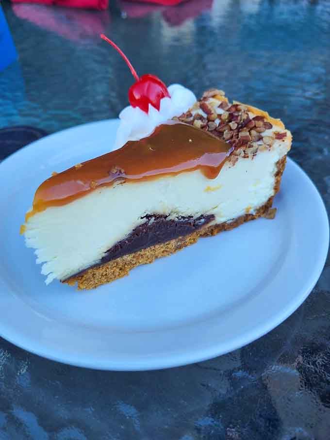 That cheesecake slice, draped in caramel with a cherry on top, is basically a standing ovation on a plate.