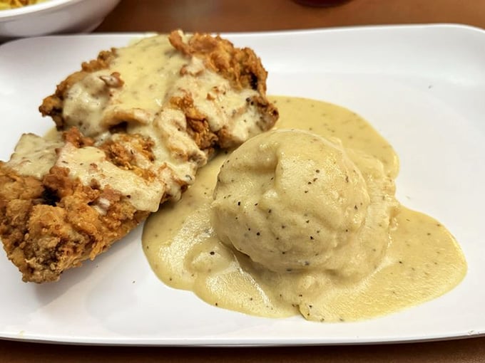 Chicken fried steak swimming in peppery gravy with fluffy mashed potatoes is comfort food that could cure a bad day.