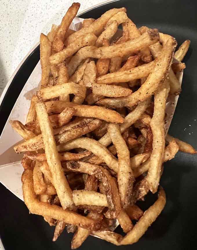 Hand-cut fries with all their glorious irregular shapes, creating the perfect mix of crispy and tender in every bite.