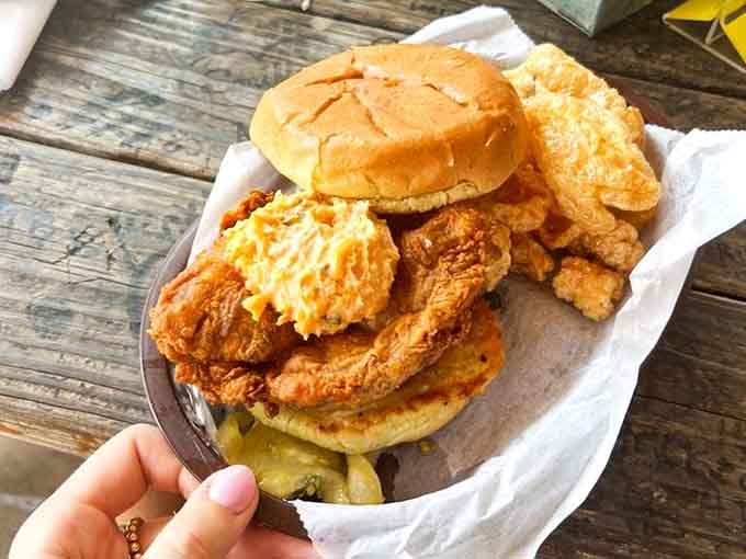 Golden fried chicken stacked high on a bun, proving that sometimes simple perfection needs no introduction whatsoever.