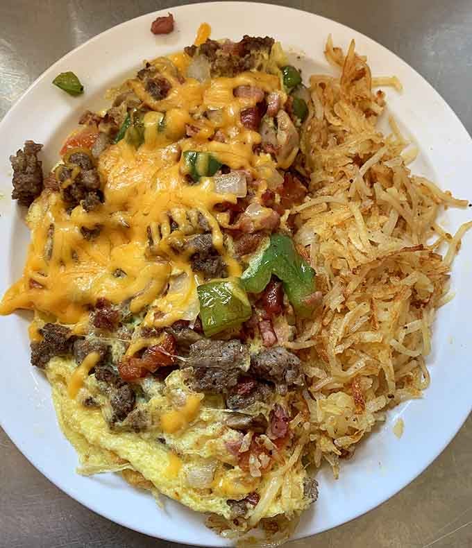 Fluffy eggs, melted cheese, and crispy hash browns create the holy trinity of comfort food mornings.
