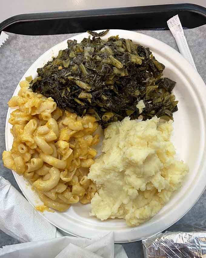 Mac and cheese, collard greens, and mashed potatoes create the holy trinity of Southern comfort on one blessed plate.