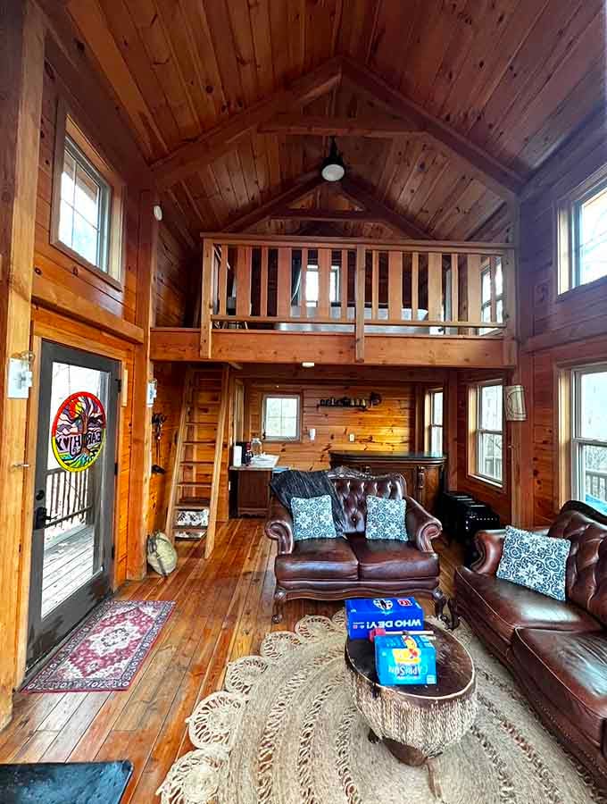 Cathedral ceilings and a sleeping loft make this interior surprisingly spacious for something built around actual tree trunks.