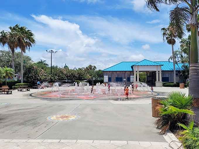 Splash pads where kids run wild while parents remember simpler times with garden hoses.