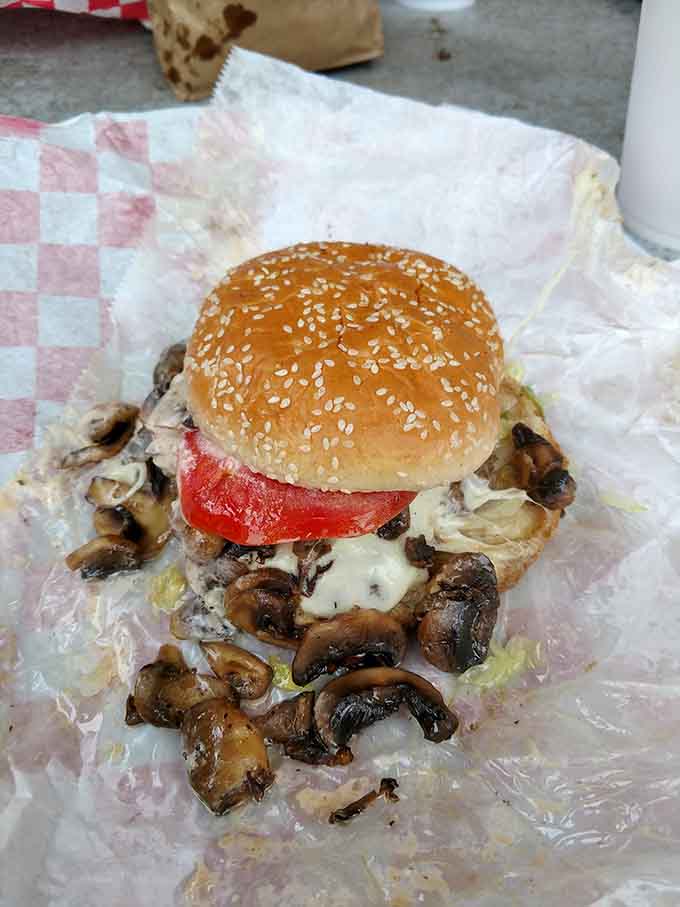 The Black Widow burger lives up to its dramatic name with mushrooms cascading over melted cheese like edible treasure.