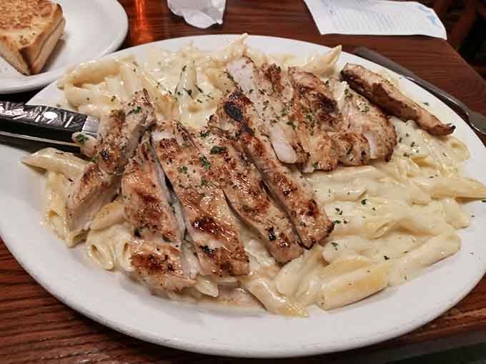 Grilled chicken over creamy pasta shows this kitchen can handle Italian-American classics with the same confidence as Southern staples.
