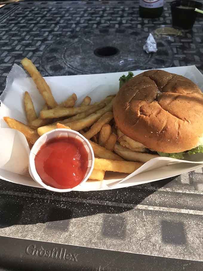 Golden fries and a perfectly grilled burger make this outdoor meal taste like pure Kentucky summer happiness.