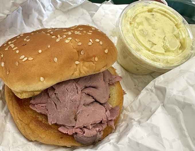 That sesame seed bun holds more tender roast beef than seems physically possible, with potato salad backup.