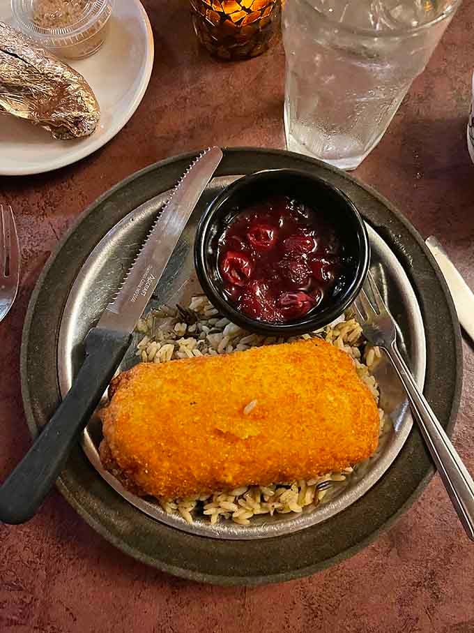 Chicken Kiev oozing butter over rice is comfort food elevated to an art form worth celebrating properly.