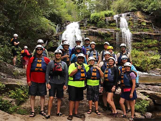 Nothing says "we survived" quite like a group photo with a stunning waterfall backdrop.