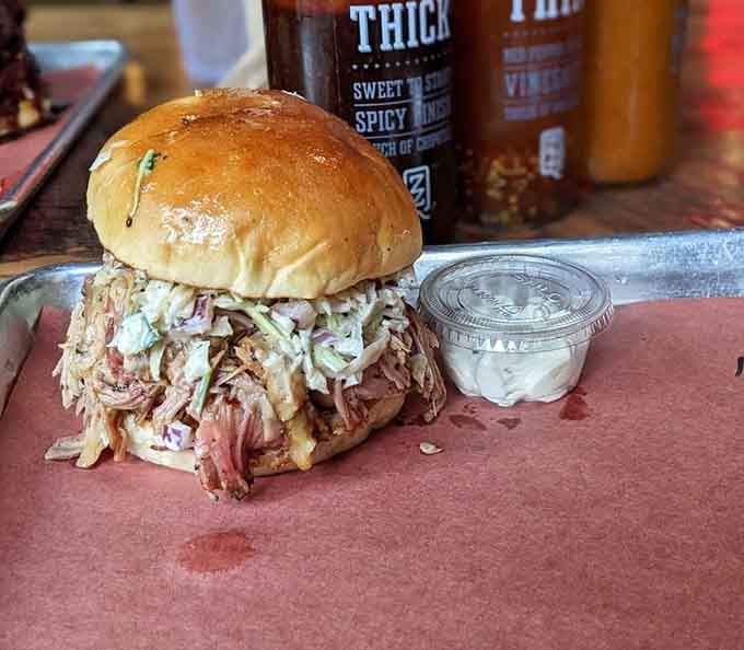Pulled pork piled high with tangy slaw creates the kind of sandwich that requires extra napkins and zero regrets.