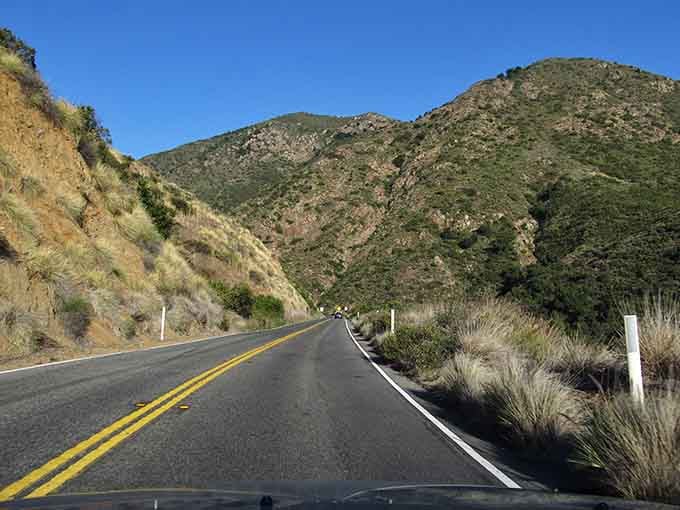 Rugged peaks rising beside smooth asphalt create the kind of contrast that makes you grab your camera.