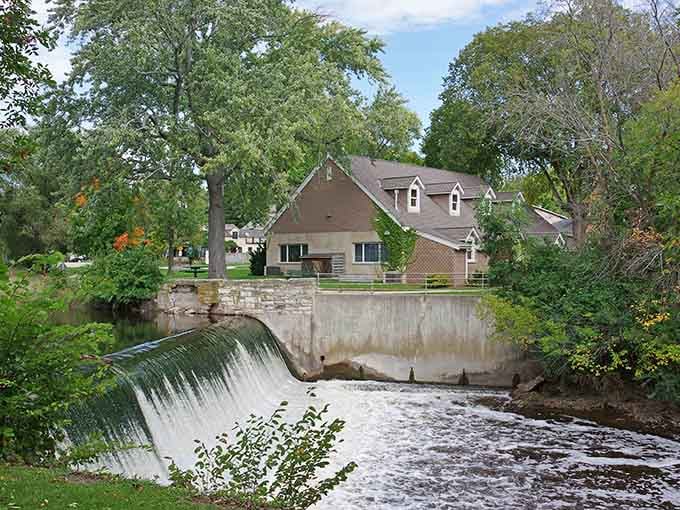 Water cascades over the dam while homes nestle nearby, proving Cedarburg knows how to blend nature with neighborhood.
