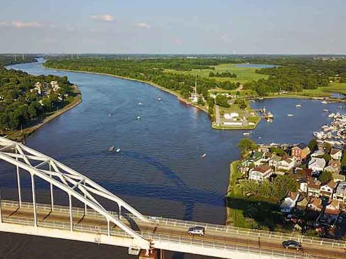 The canal cuts through green landscape like nature's highway, bringing boats and adventure right to your doorstep.
