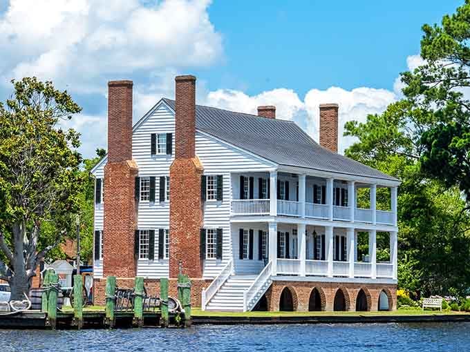 This waterfront mansion sits gracefully by the river like a Southern belle at her finest garden party.