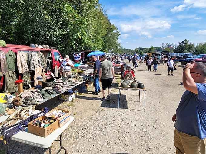 Shoppers stroll the gravel pathways between tables loaded with everything from vintage tools to forgotten household treasures.