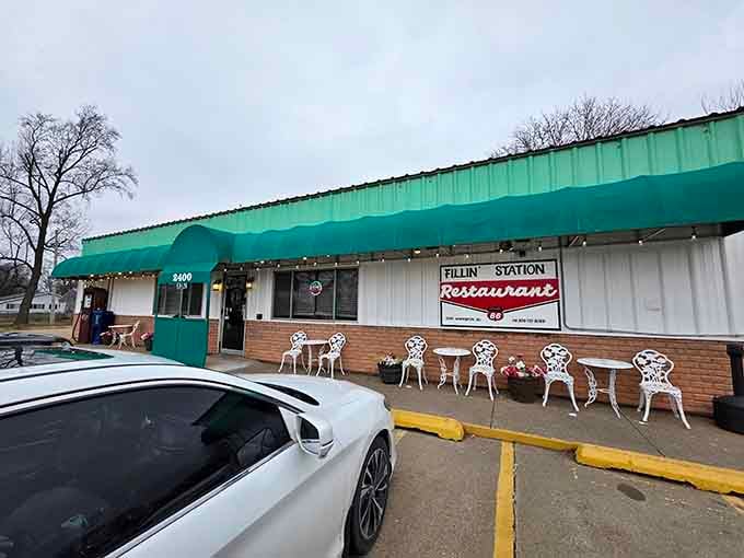 The turquoise awning and vintage white chairs outside promise a dining experience that honors simpler, sweeter times perfectly.