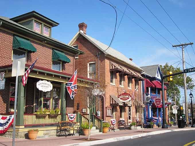 Patriotic decorations and brick storefronts create an inviting Main Street where history happened and visitors still come to remember it.