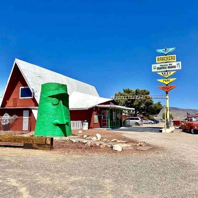 Route 66 kitsch meets Easter Island mystery at this quirky roadside stop where vintage signs point toward pure Americana.