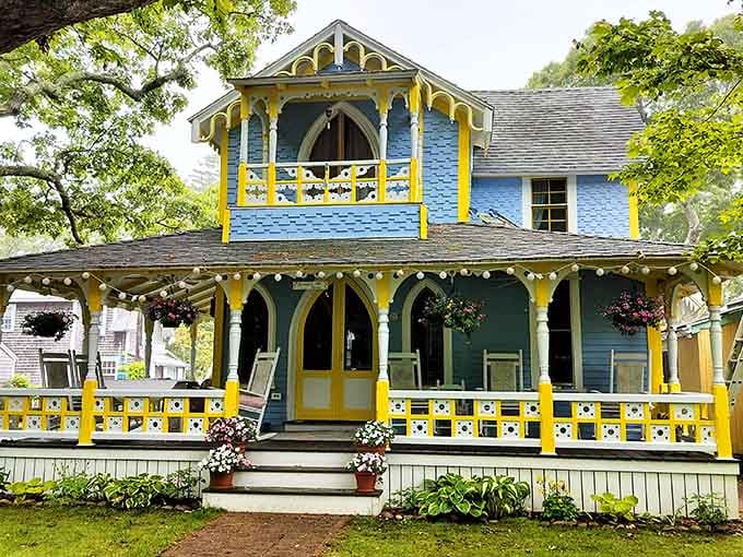 Bright yellow trim pops against blue siding like a Victorian-era celebration frozen in time and cheerful color.