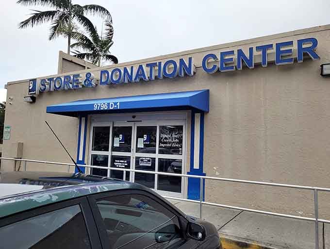 The blue awning and palm tree create a welcoming entrance where shopping meets community service in perfect harmony.
