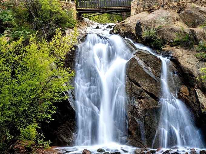 Cascading over dark rocks with silky smoothness, this waterfall creates its own peaceful soundtrack.