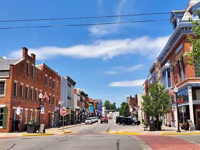This downtown stretches wide under dramatic skies, where colorful storefronts tell stories of circus history and community pride.