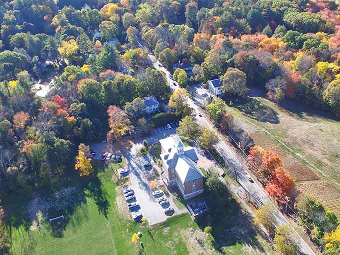From above, autumn paints the landscape in brilliant colors while farms and fields nestle among the vibrant trees.