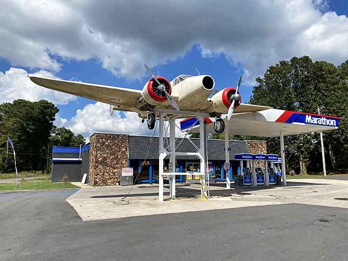 A vintage twin-engine beauty perches above the gas pumps like Amelia Earhart decided to open a convenience store!
