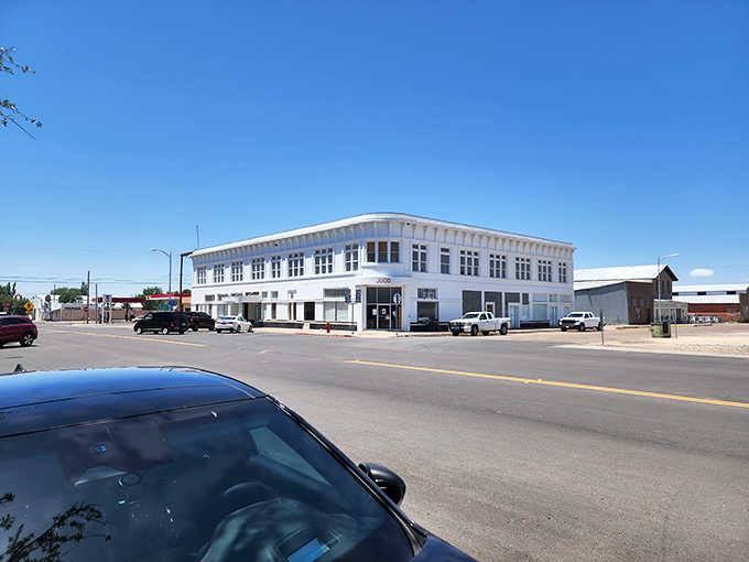 That striking white building commands attention like a movie set, standing crisp and clean against endless West Texas sky.